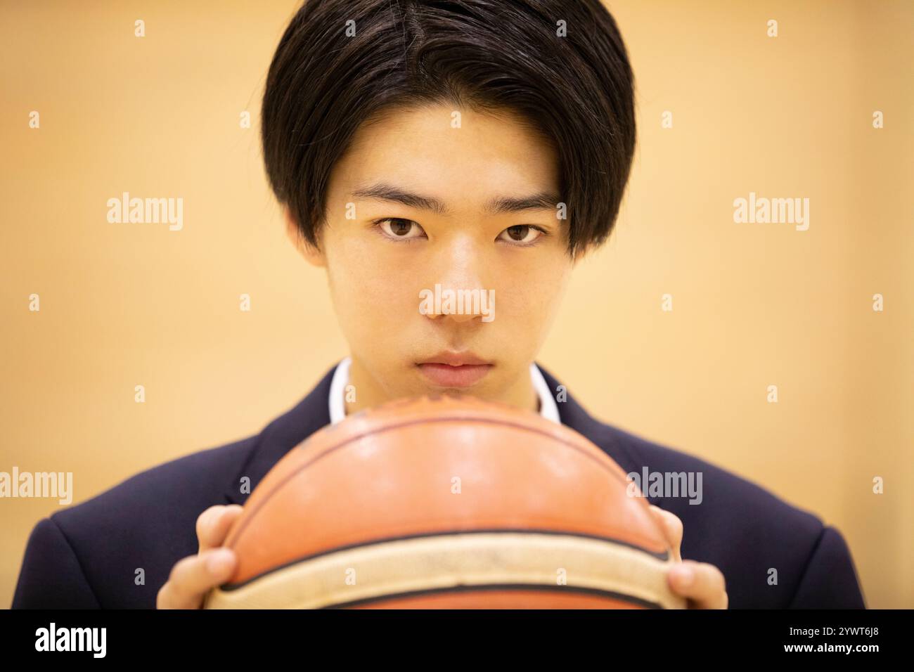 High school student staring ahead with basketball in hand Stock Photo ...
