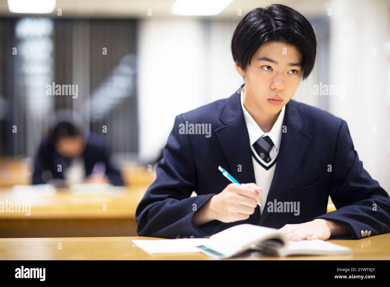 High school boy thinking while studying Stock Photo - Alamy