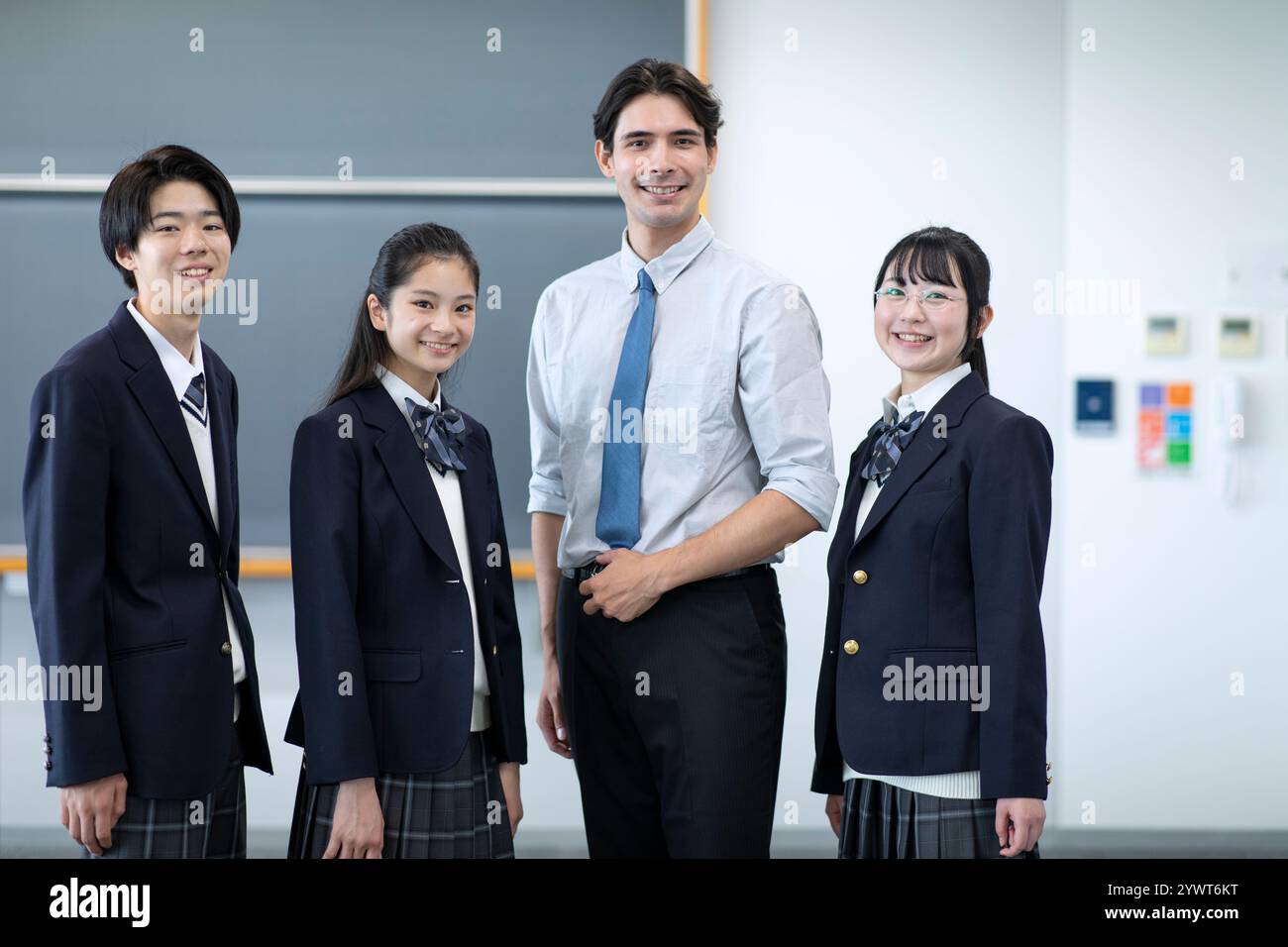 High school students smiling alongside their foreign teacher Stock ...