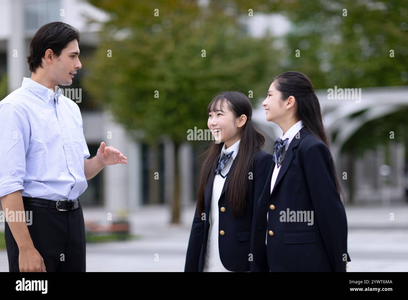 High school girl talking with a foreigner Stock Photo - Alamy