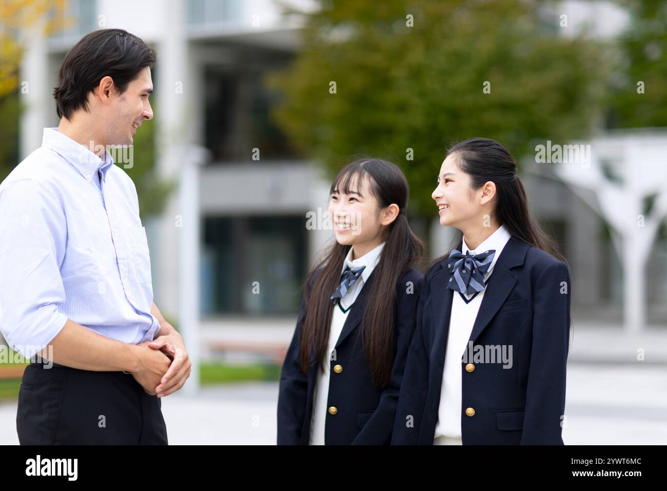 High school girl talking with a foreigner Stock Photo - Alamy