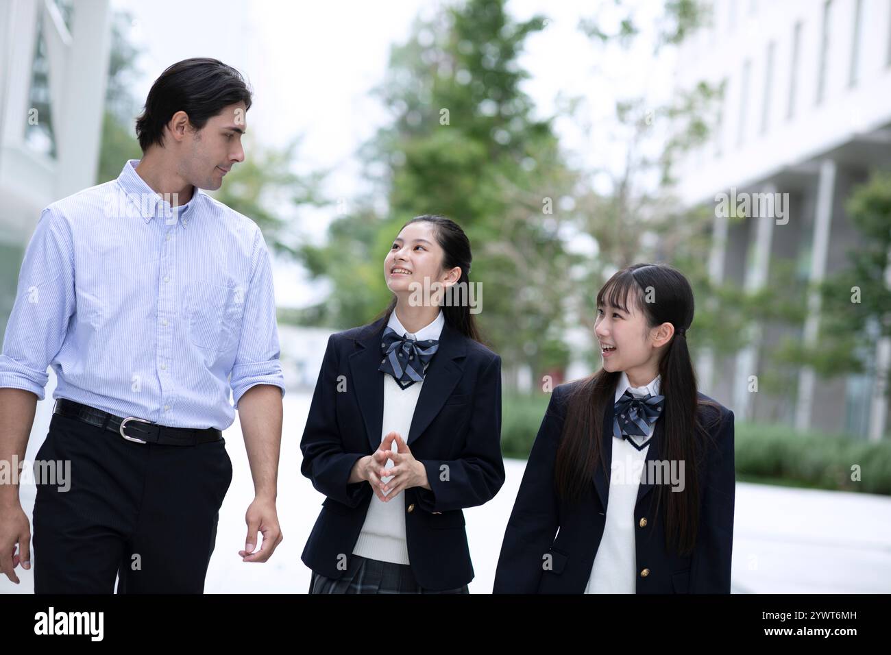 High school student walking while talking to a foreigner Stock Photo ...