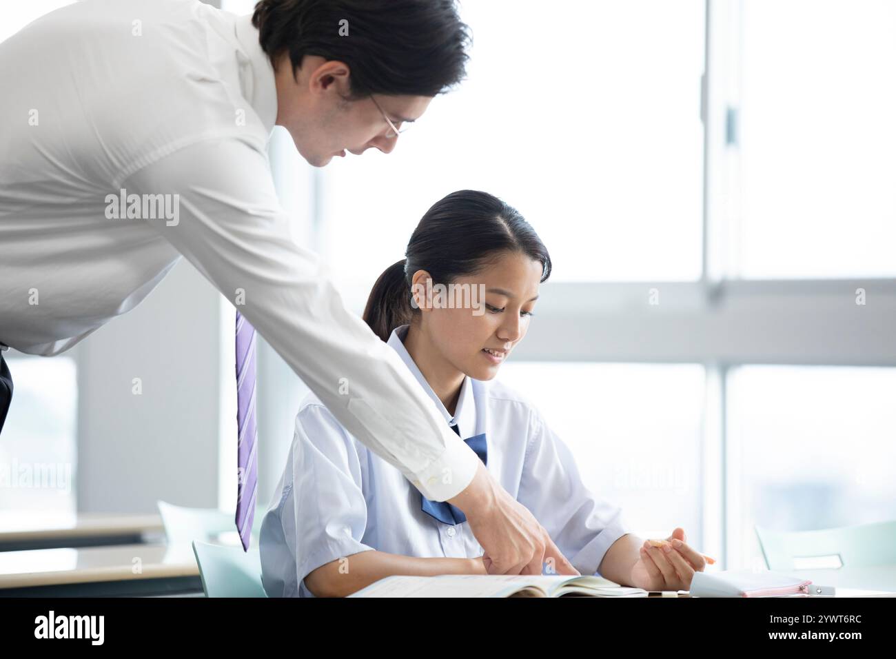 Female high school student receiving advice from teacher Stock Photo ...