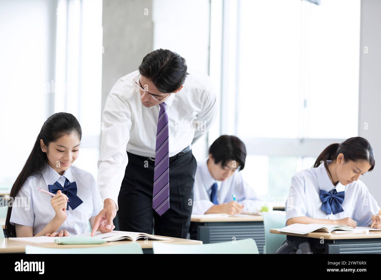 Female high school student receiving advice from teacher Stock Photo ...