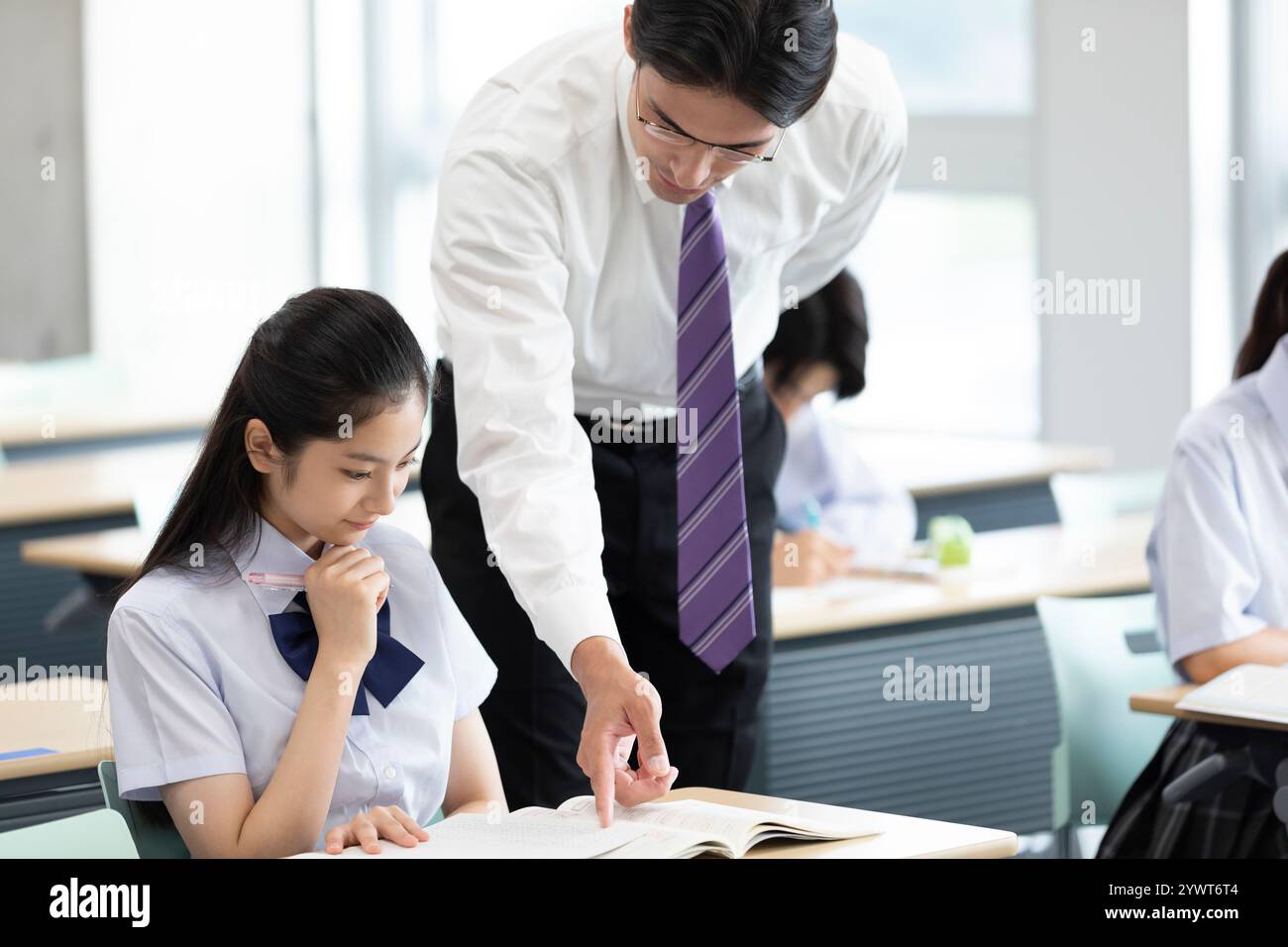 Female high school student receiving advice from teacher Stock Photo ...