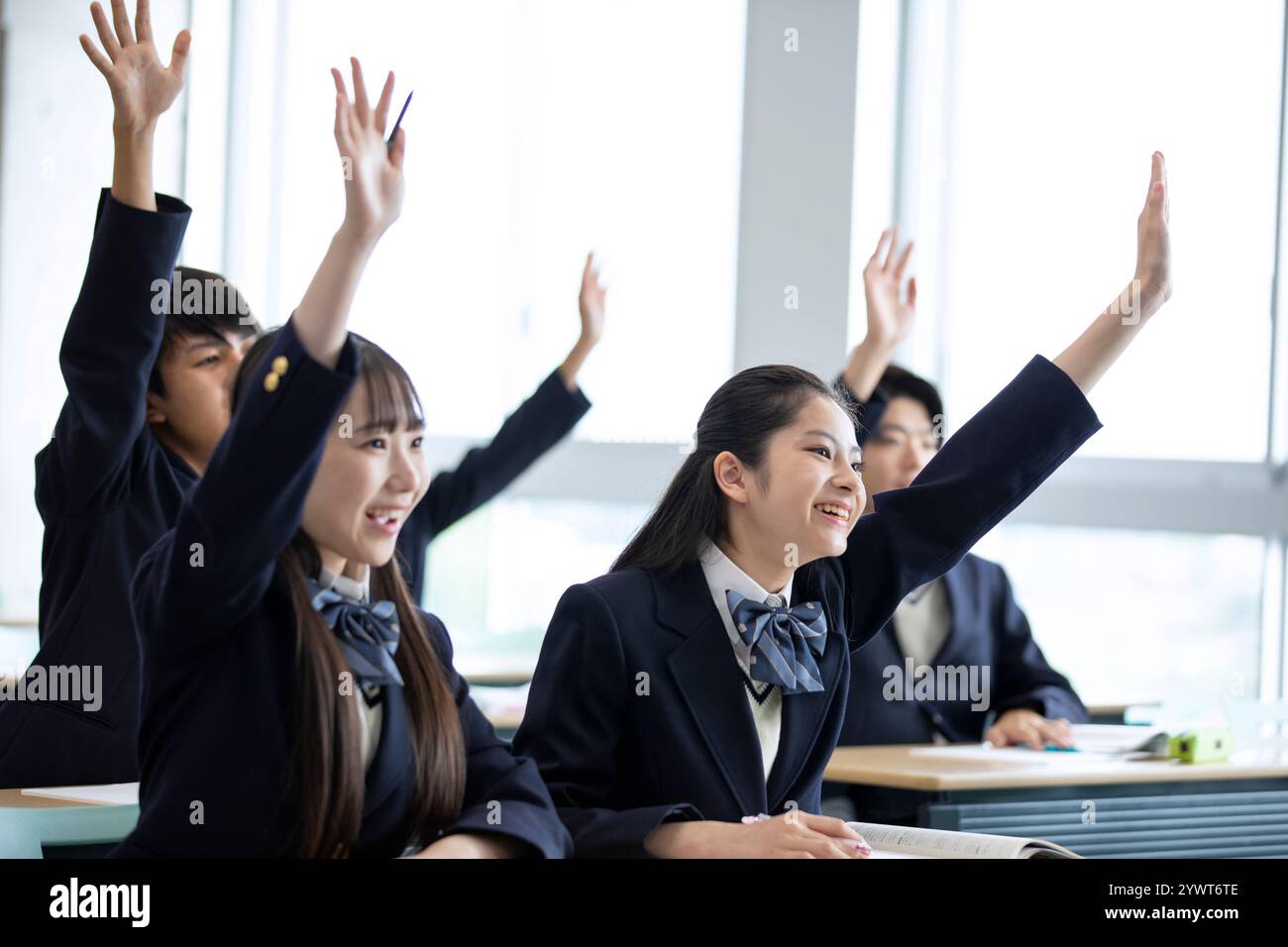 High school students raising their hands in class Stock Photo - Alamy