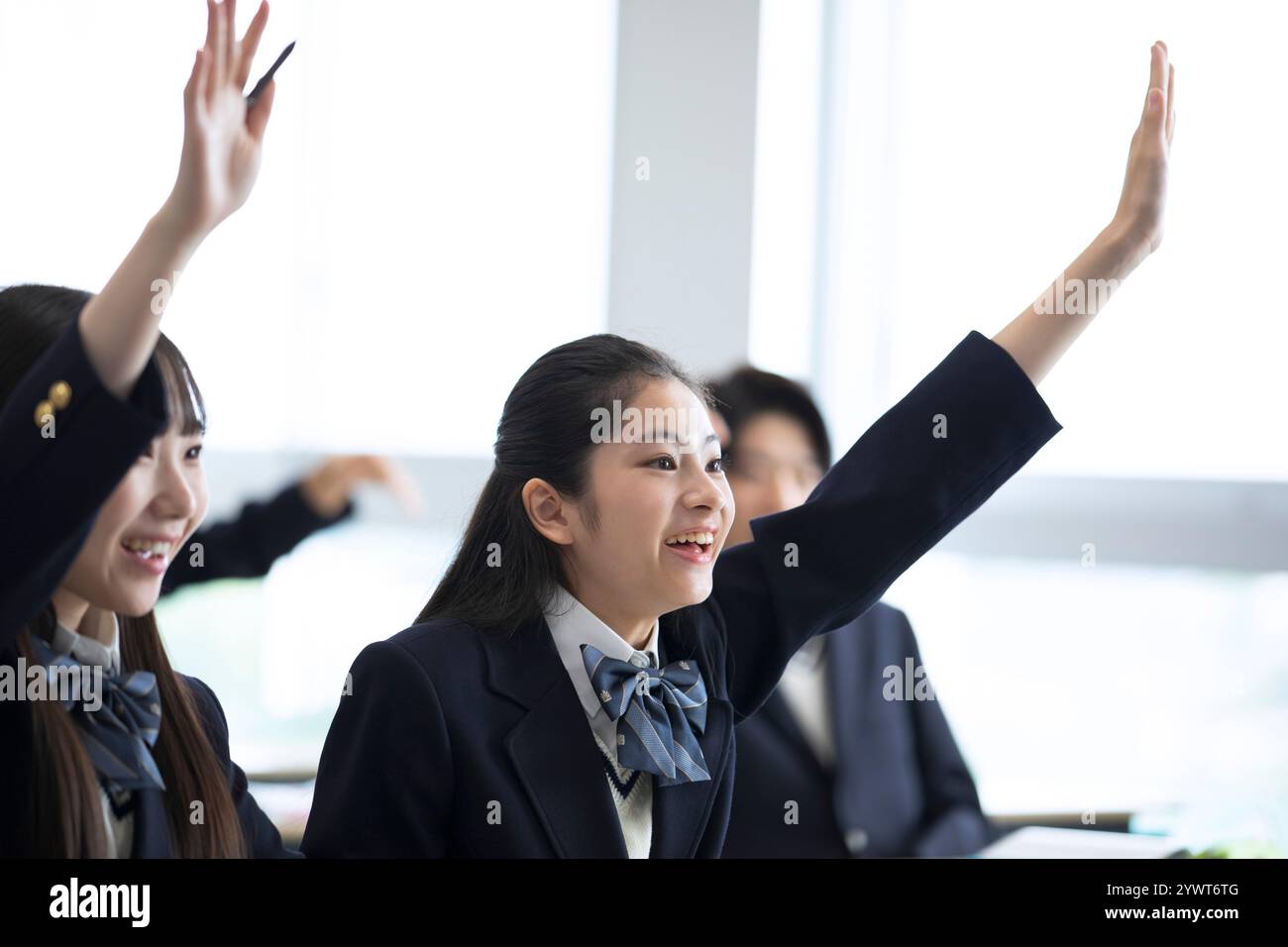 High school students raising their hands in class Stock Photo - Alamy