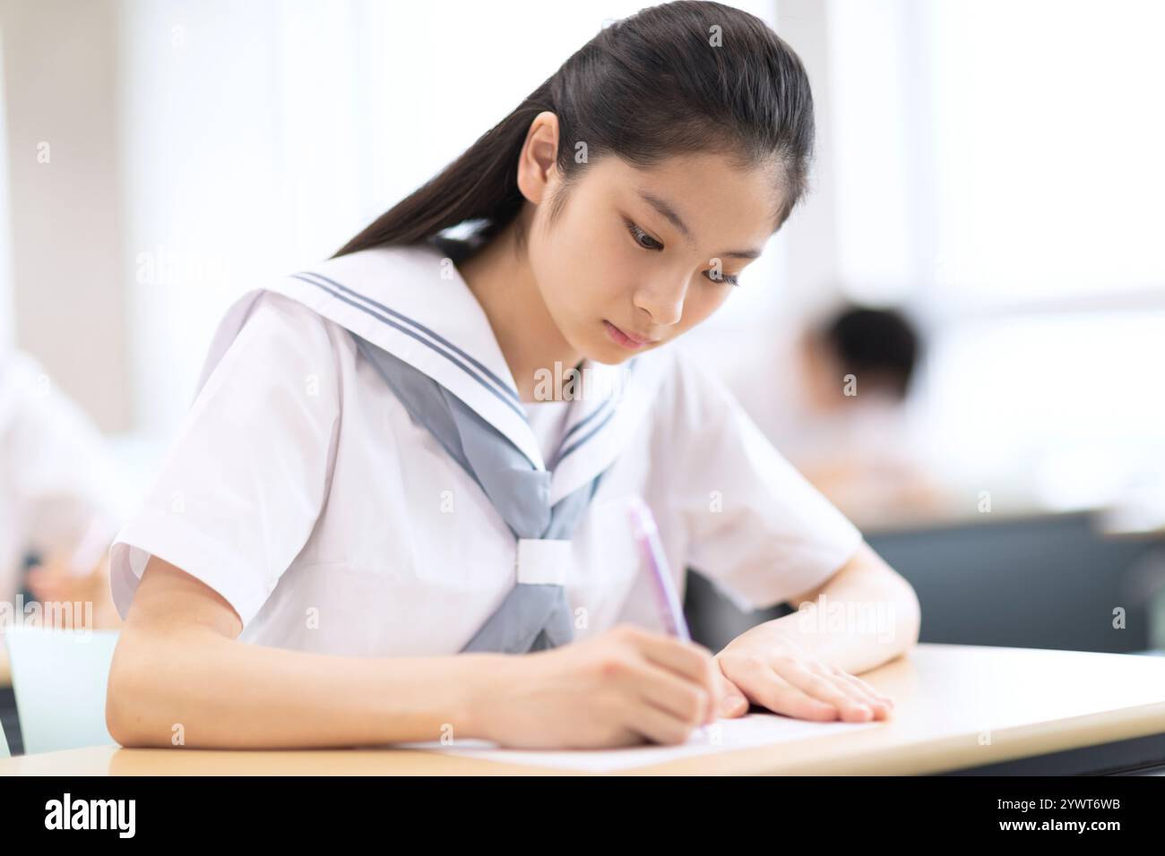 Female high school students taking a test Stock Photo - Alamy
