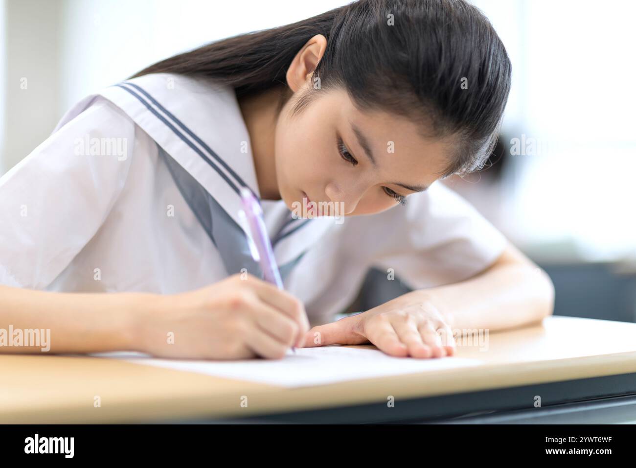 Female high school students taking a test Stock Photo - Alamy