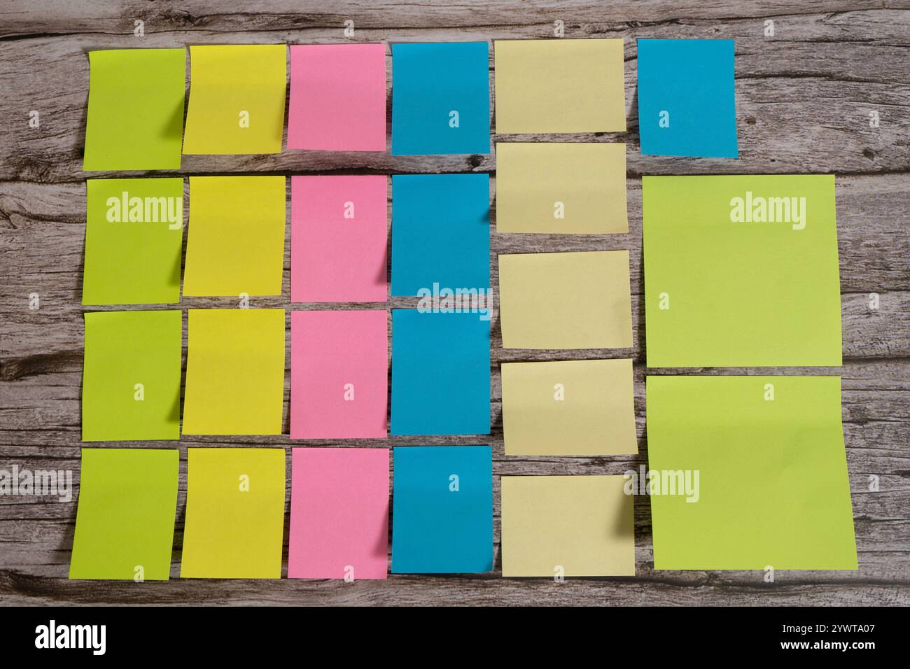 A Post-it notes and sticky notes sorted by color and size on a table ...