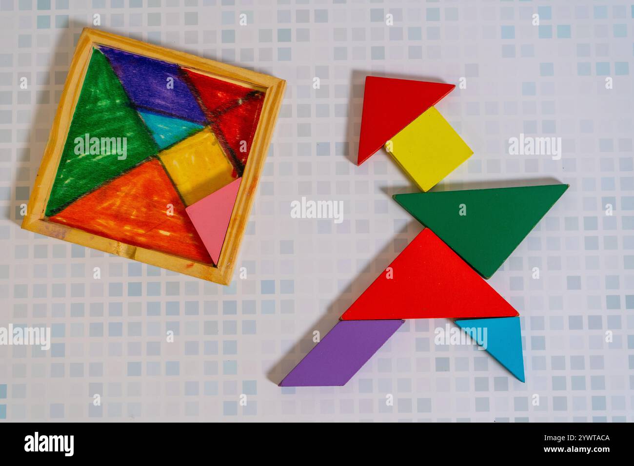 A Colorful Tangram puzzle forming a figure with its container on a ...
