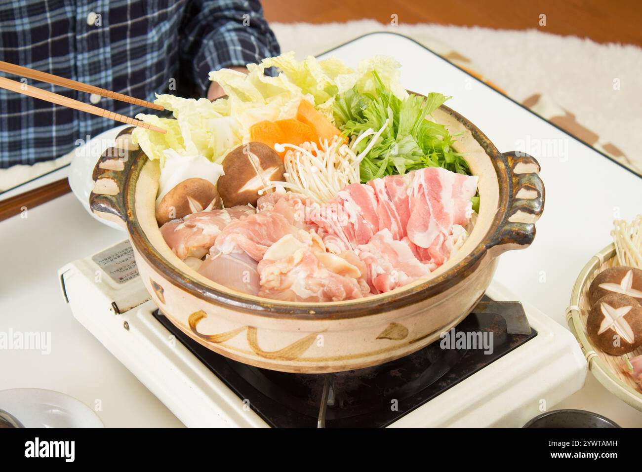 Japanese couple eating a nabe dish Stock Photo - Alamy