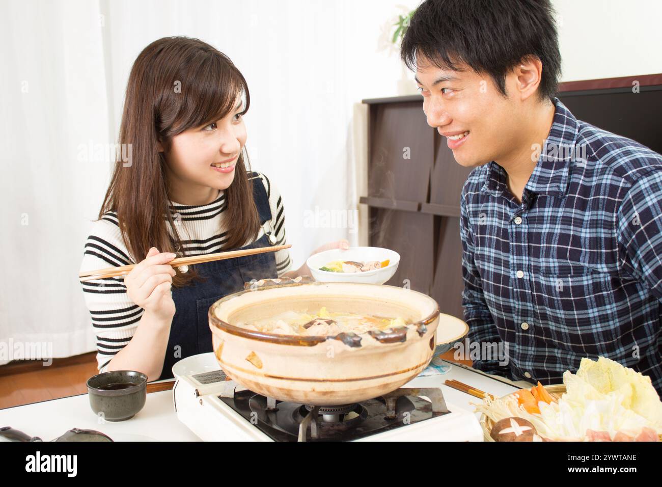 Japanese couple eating a nabe dish Stock Photo - Alamy