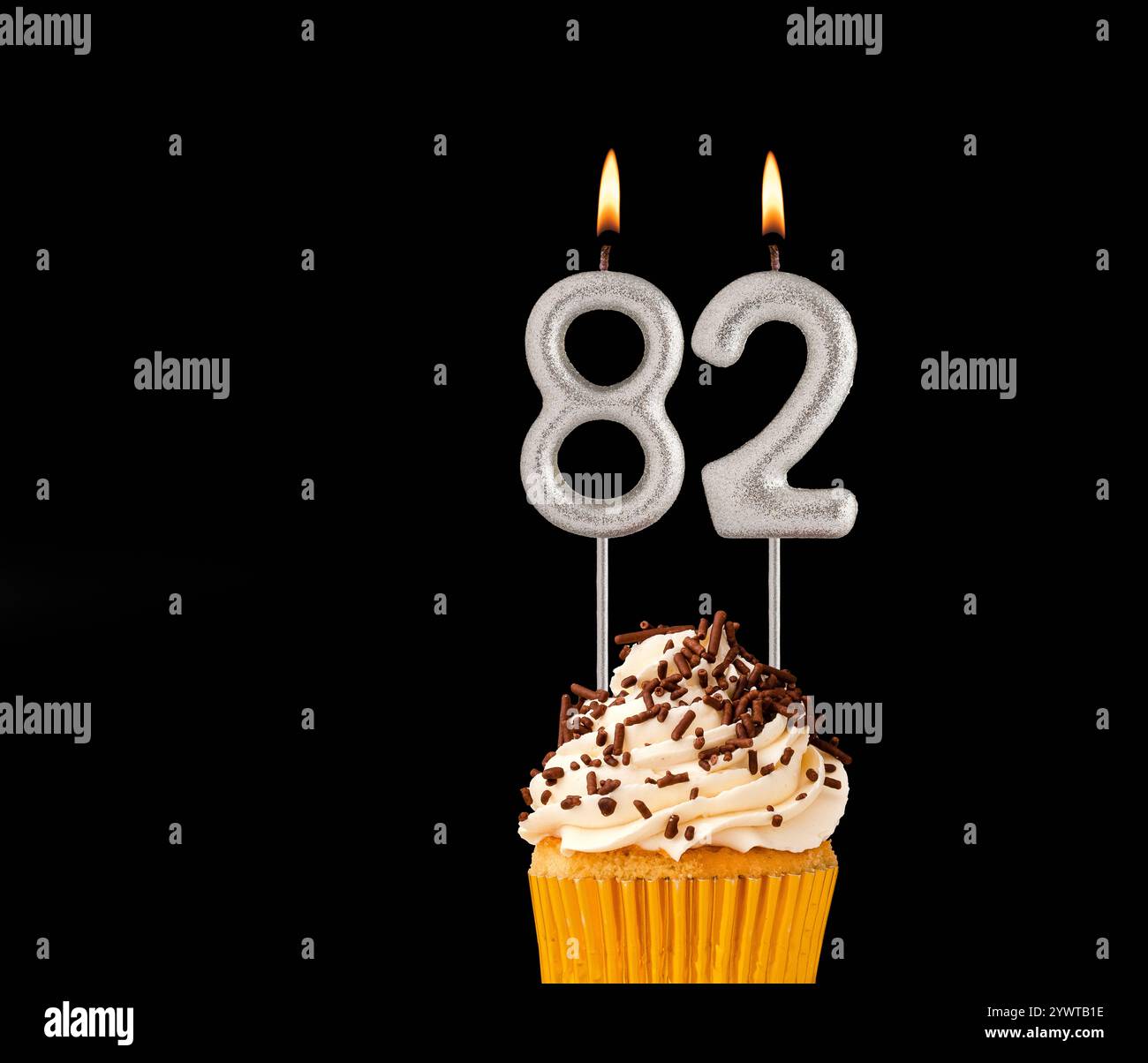 Number 82 shaped candles - Birthday cupcake on black background Stock ...