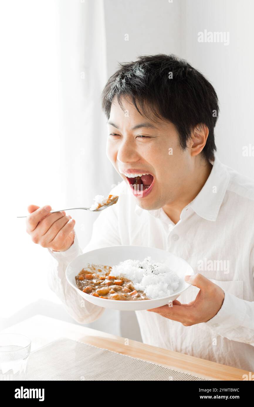 Man eating curry Stock Photo - Alamy