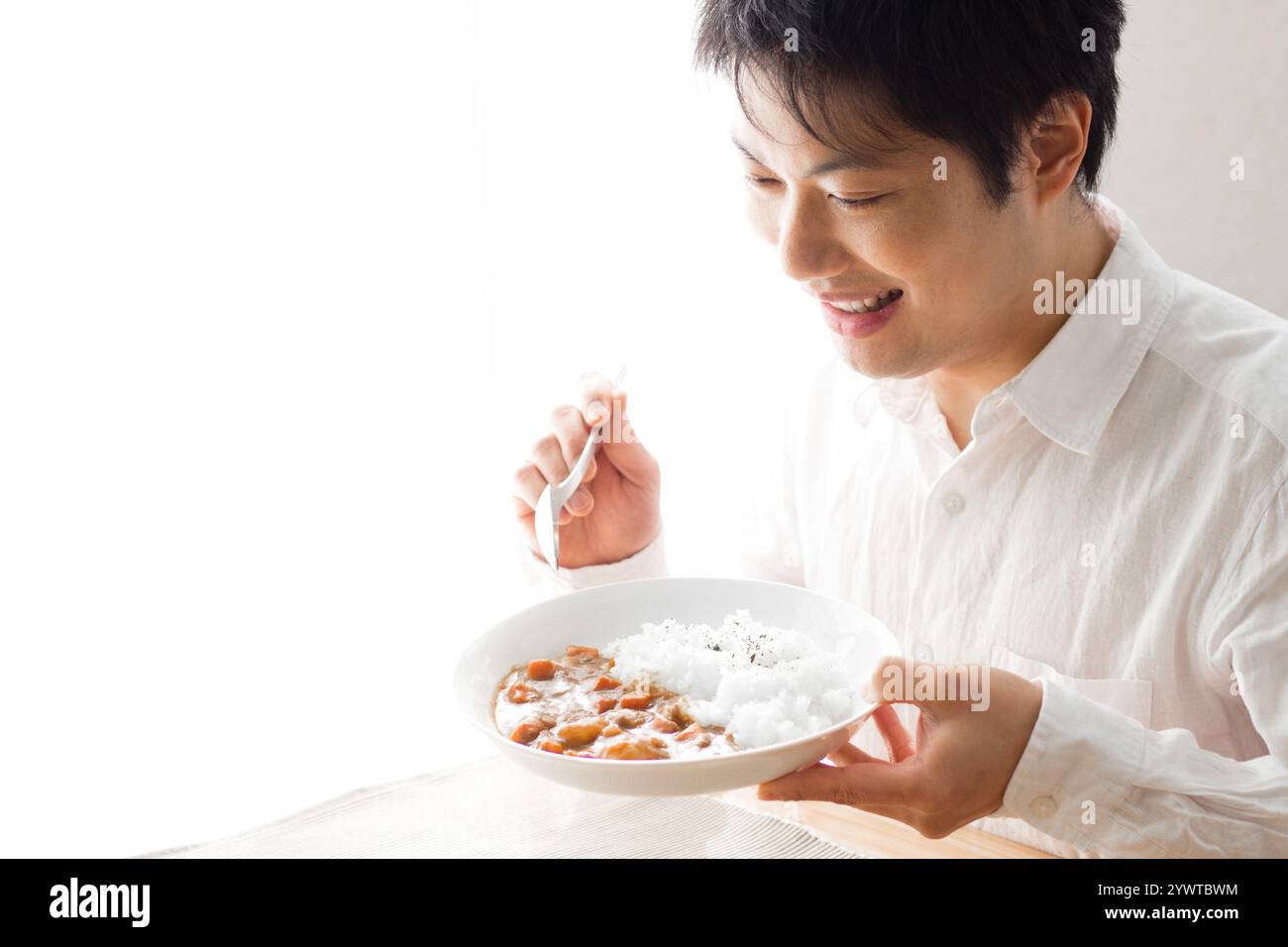 Man eating curry Stock Photo - Alamy