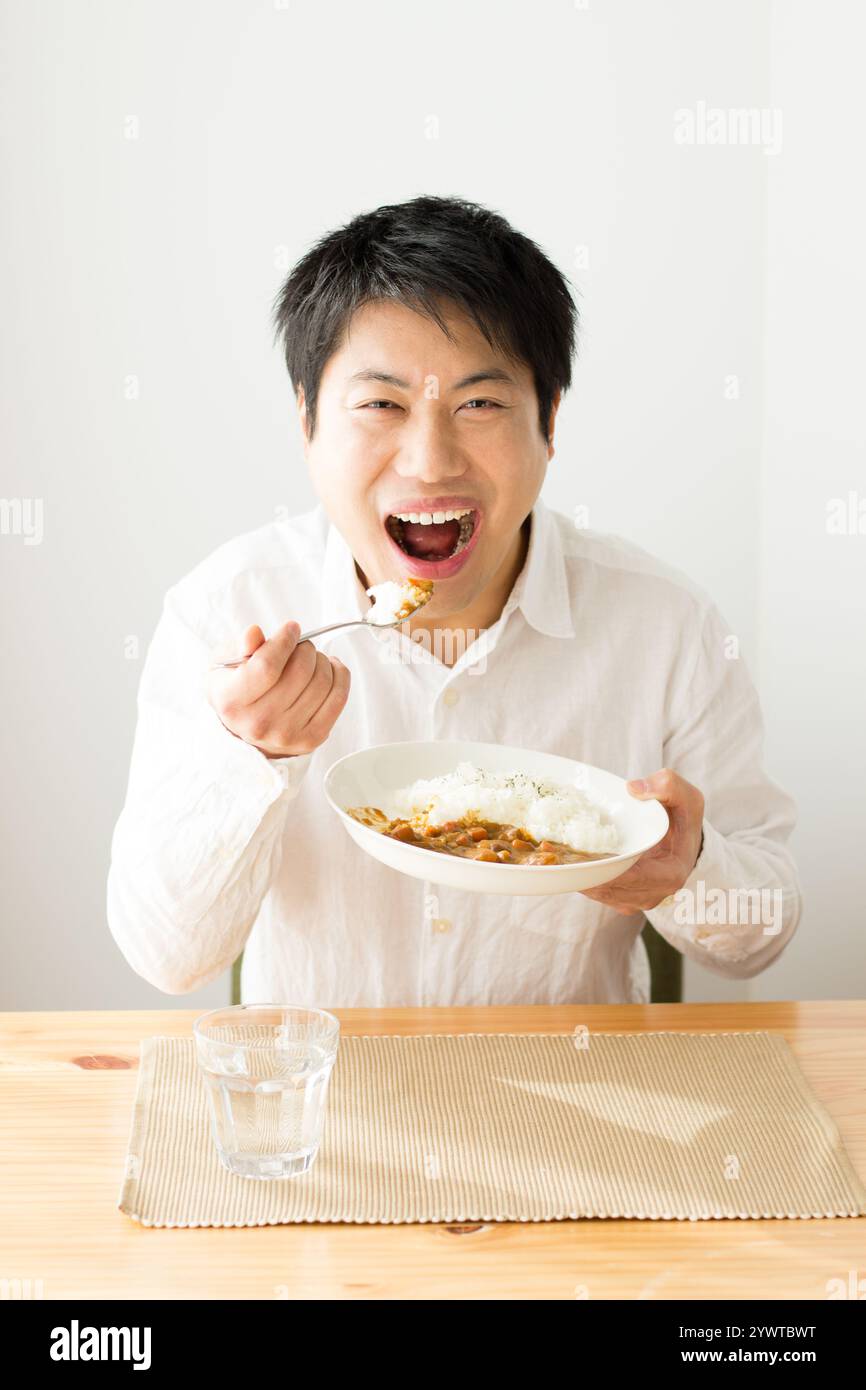 Man eating curry Stock Photo - Alamy