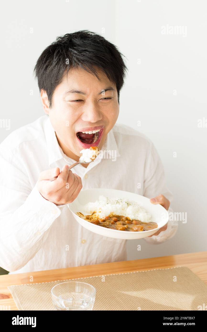 Man eating curry hi-res stock photography and images - Alamy
