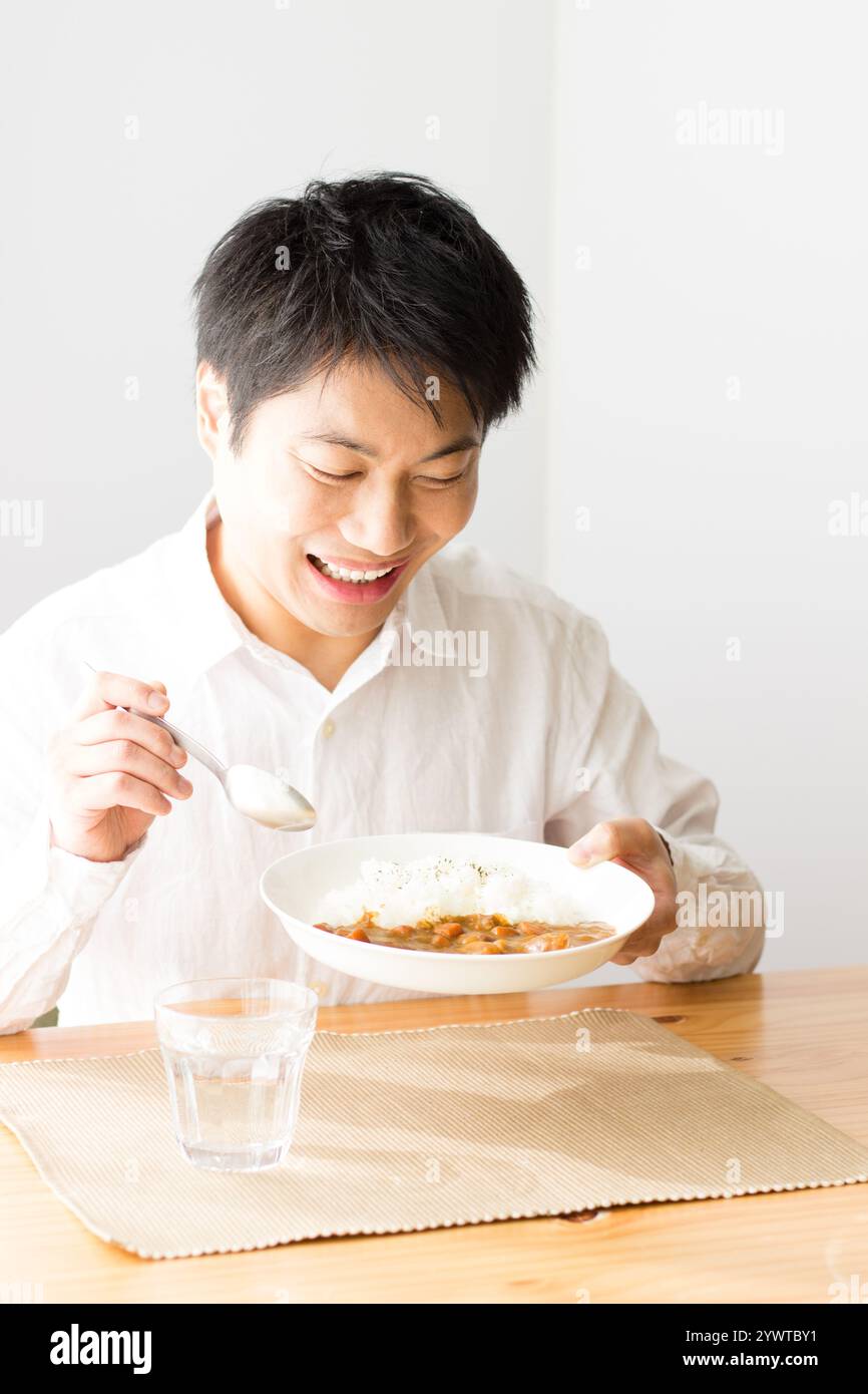 Man eating curry hi-res stock photography and images - Alamy