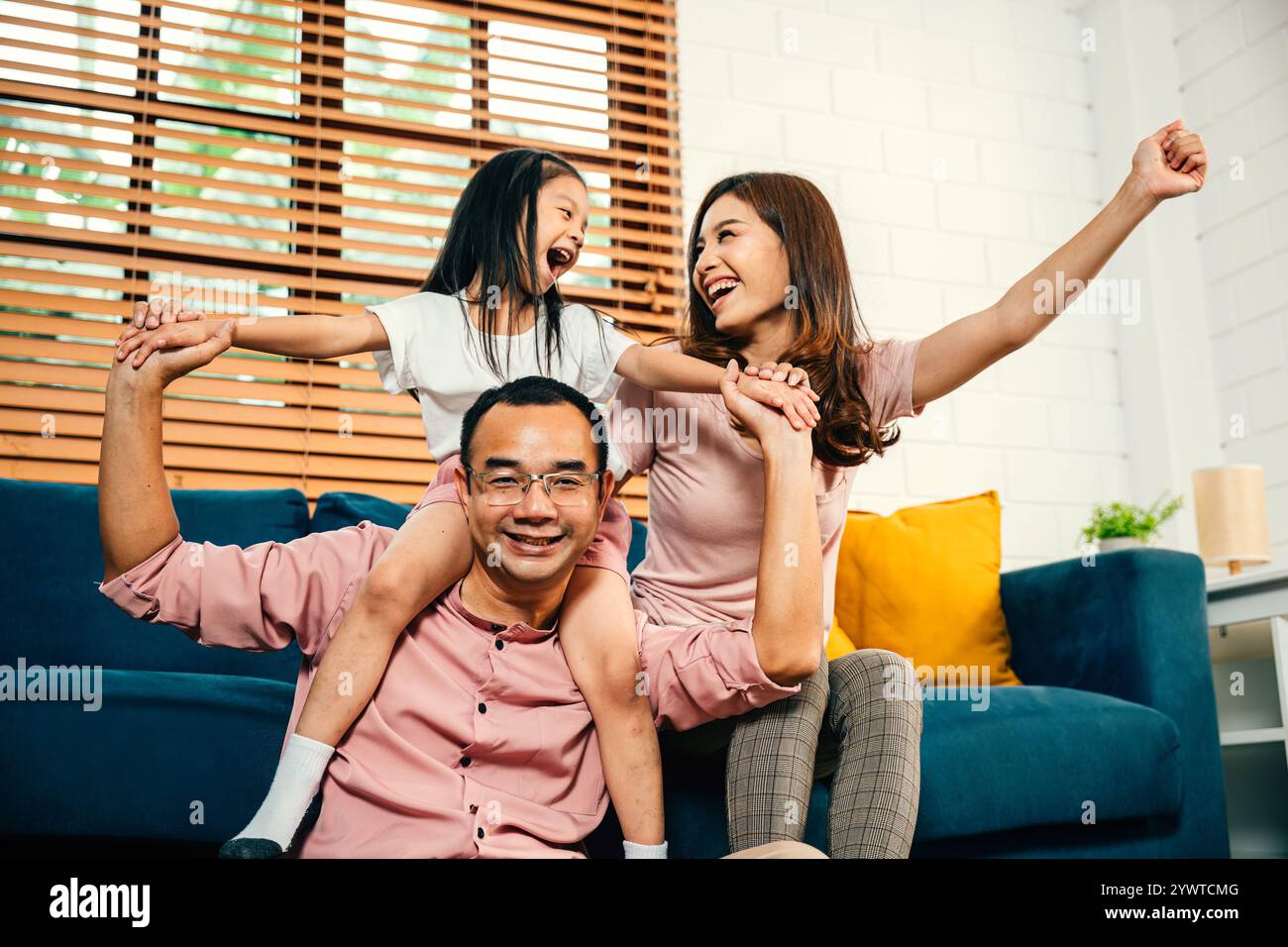 A joyful family in their comfortable modern house enjoys quality time ...