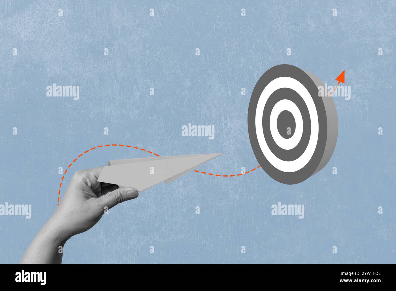 A human hand holding a paper airplane and aiming at a target with a ...