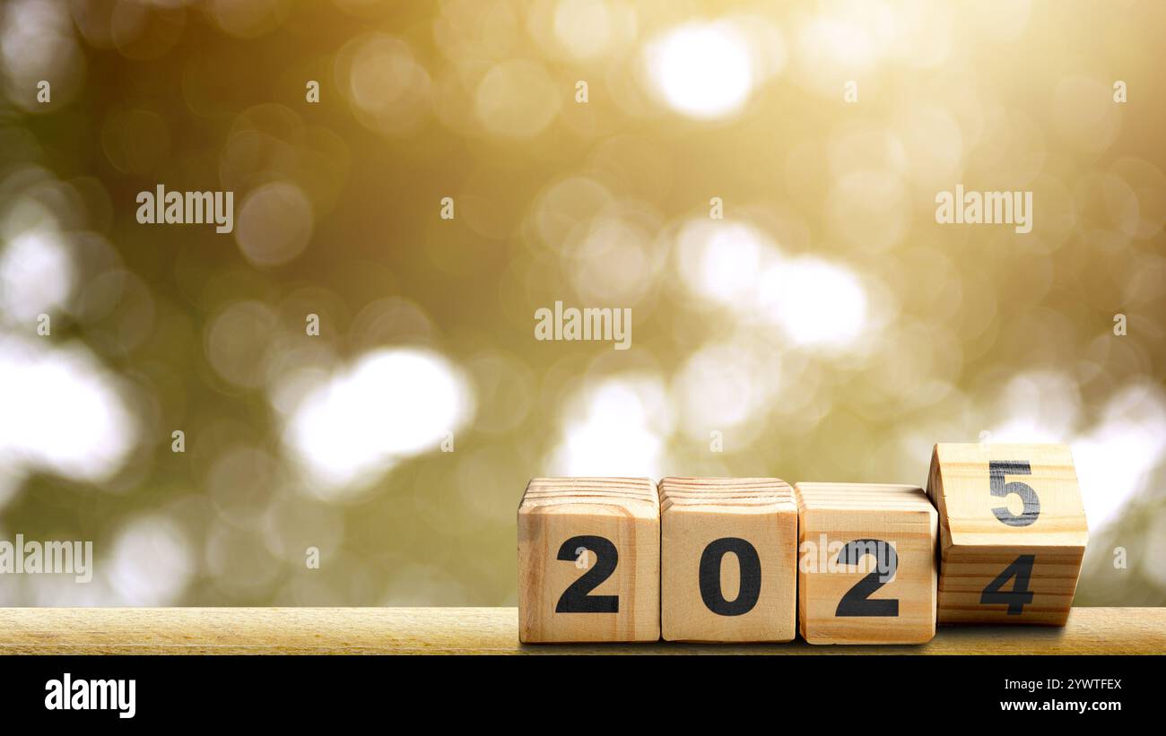 Wooden cubes transform from number 2024 to 2025 on the table. Happy New ...