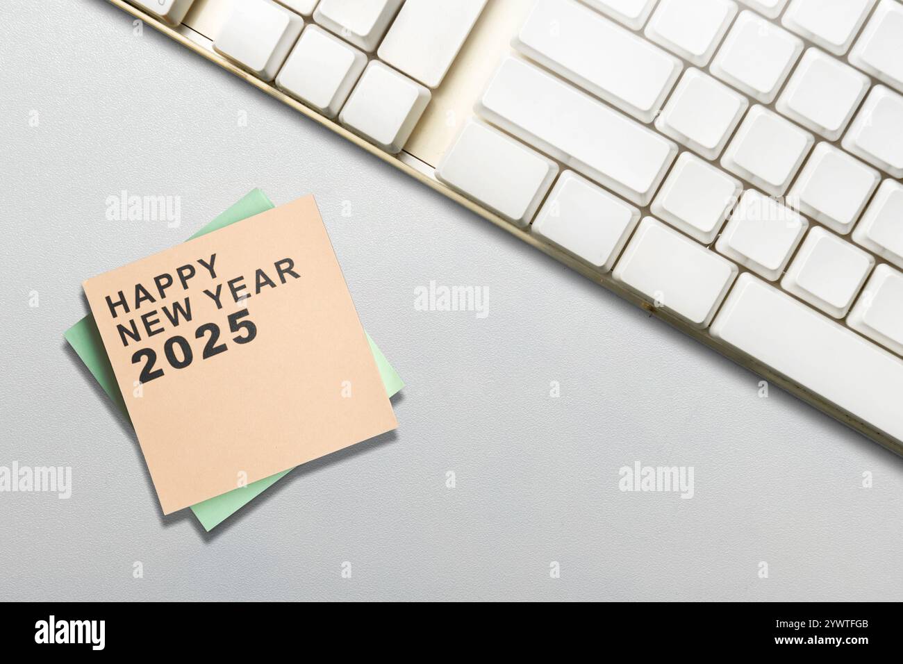 Top view of Happy New Year 2025 text written on a stack of notes paper ...