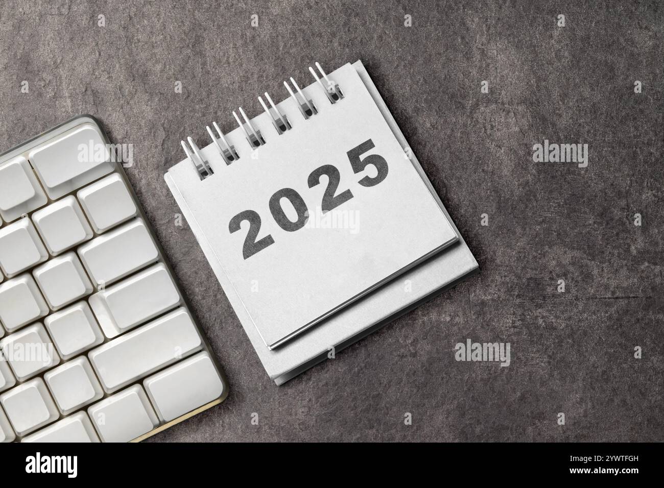 Calendar or Notepad with the number 2025 on a black background. Happy ...