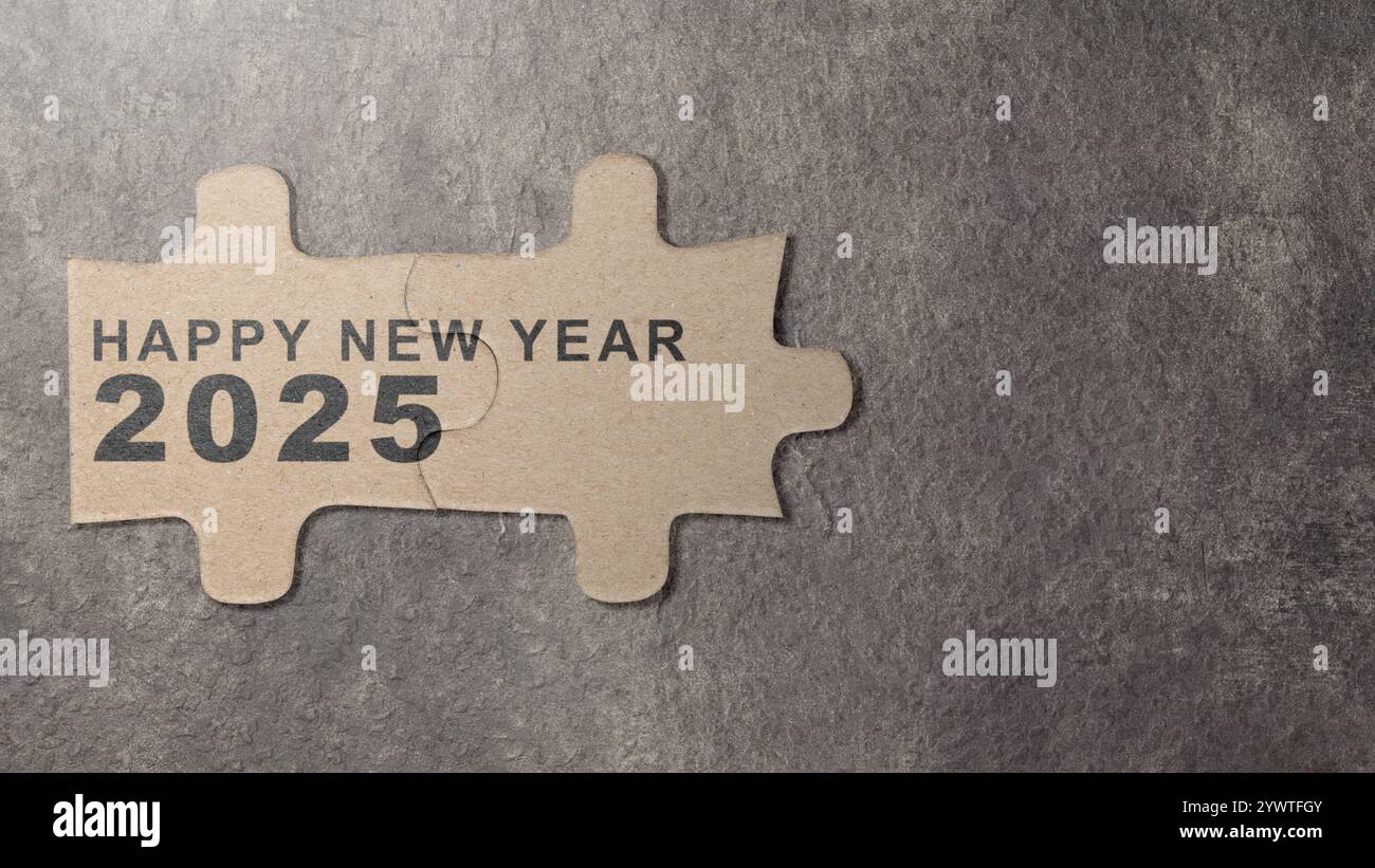 Jigsaw puzzle piece with text of Happy New Year 2025 on a black ...