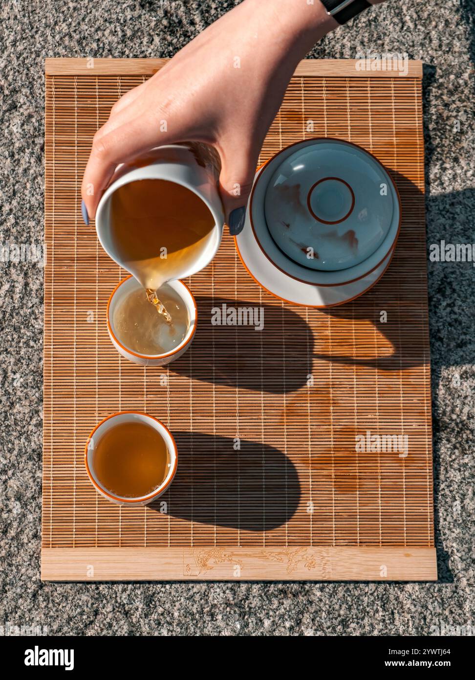 An Elegant Tea Pouring Ceremony Conducted Over a Beautiful Bamboo ...