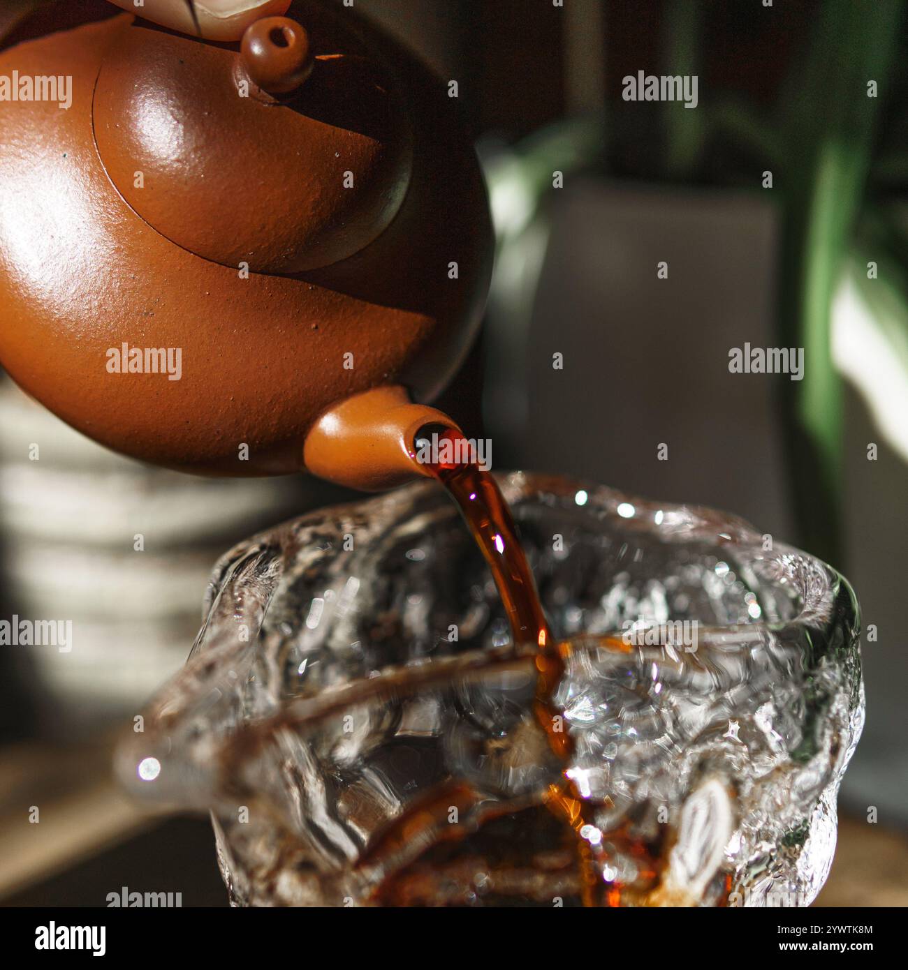 An Elegant Teapot Gently Pouring Aromatic Tea into a Clear Glass ...