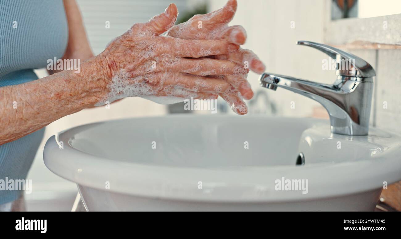 Hygiene, senior woman and washing hands in bathroom for bacteria ...