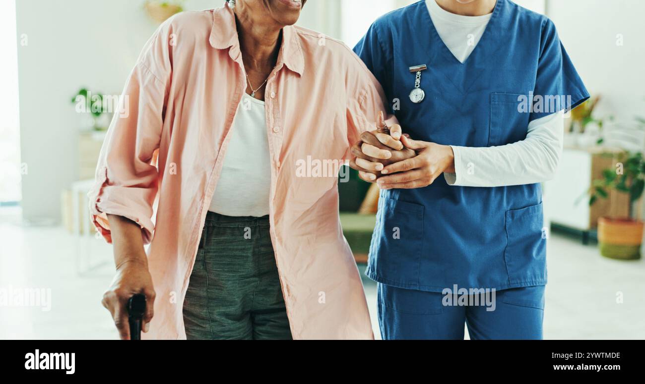 Physiotherapy, holding hands and help with walking stick for support ...