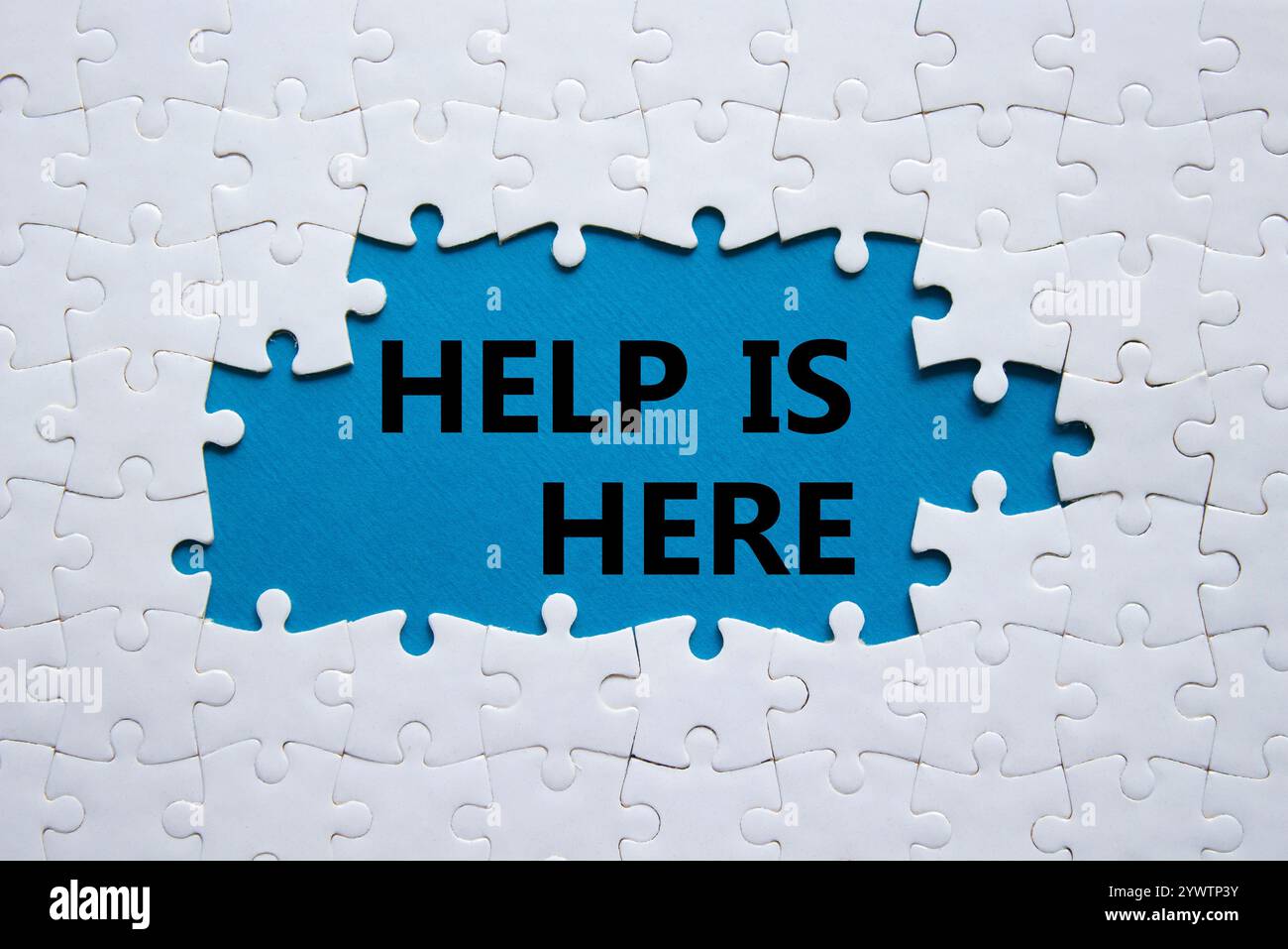 Help is here symbol. Concept words Help is here on white puzzle ...
