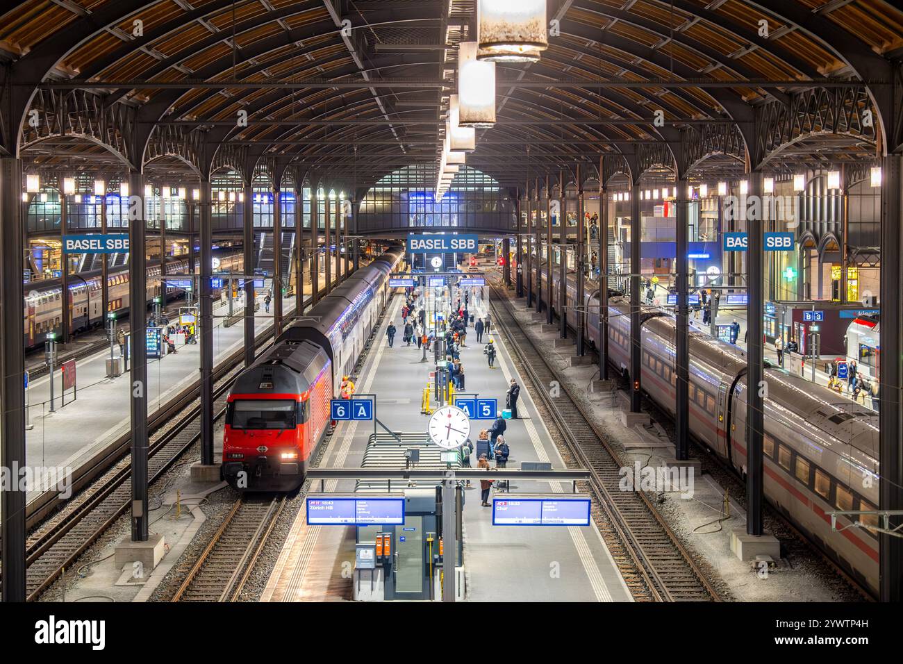 Crowded main station of Basel SBB in Switzerland with two trains in the ...