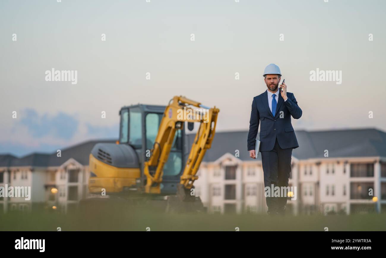 Construction business owner. Man in suit and hardhat halmet at building ...