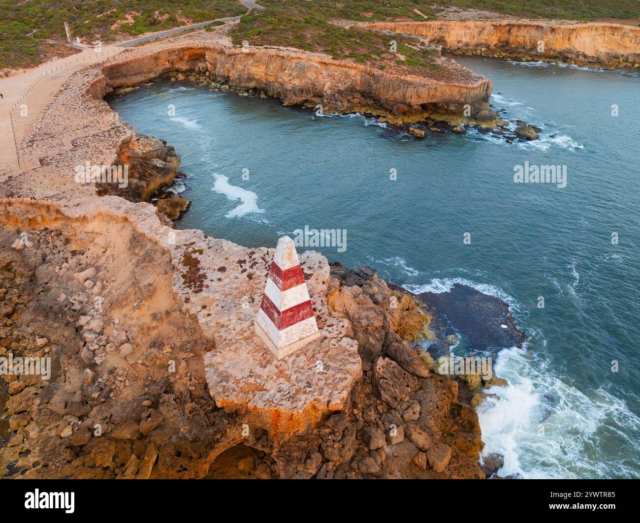 Aerial view of an obelisk monument on the edge of a rocky point at Robe ...