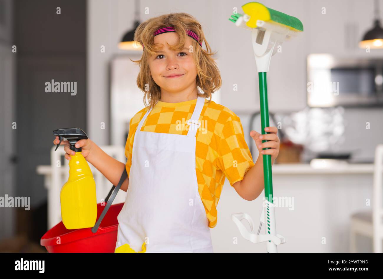 Portrait of child helping with housework, cleaning the house ...