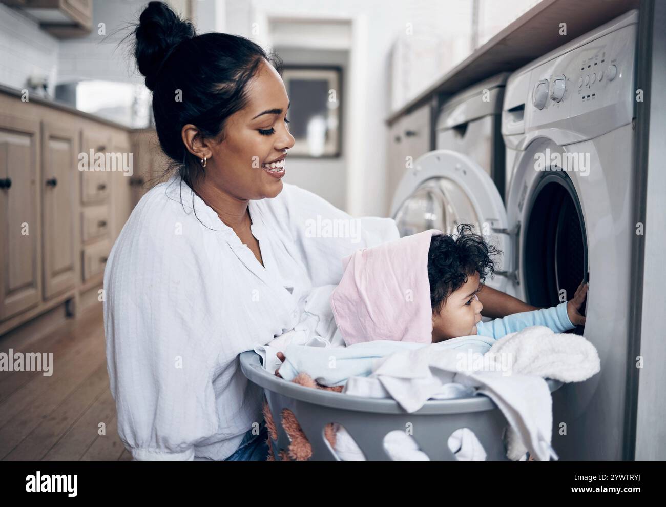Mom, baby and washing machine for laundry in home, helping mama and ...