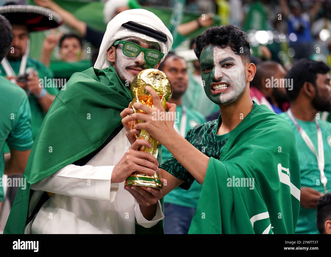 File photo dated 30/11/22 of Saudi Arabia fans with a replica world cup ...
