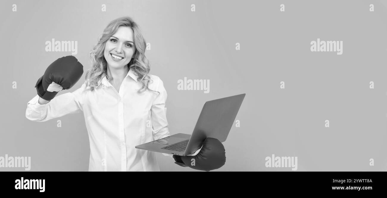 confident ceo woman in boxing gloves punching laptop, business fight ...