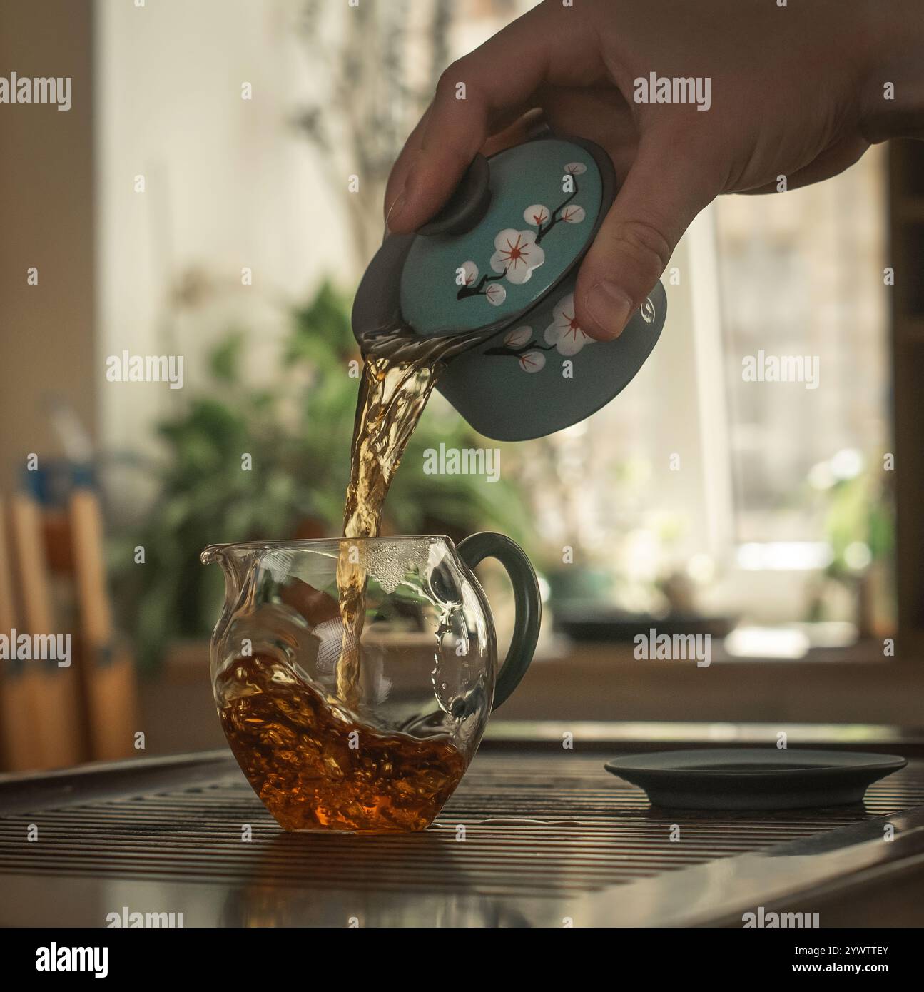 The Art of Tea Pouring a Hot Brew into a Beautiful Glass Cup for ...