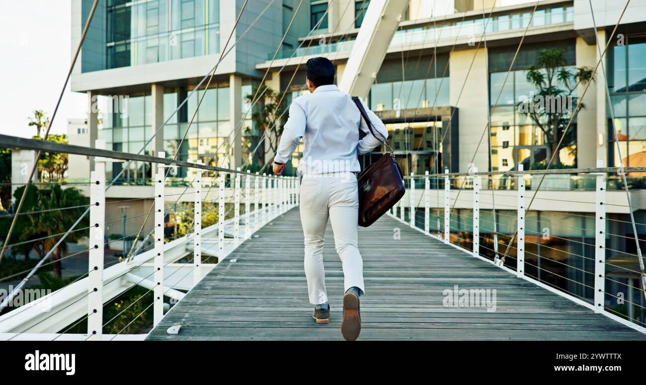 Running late, city and back with man, business and movement on bridge ...