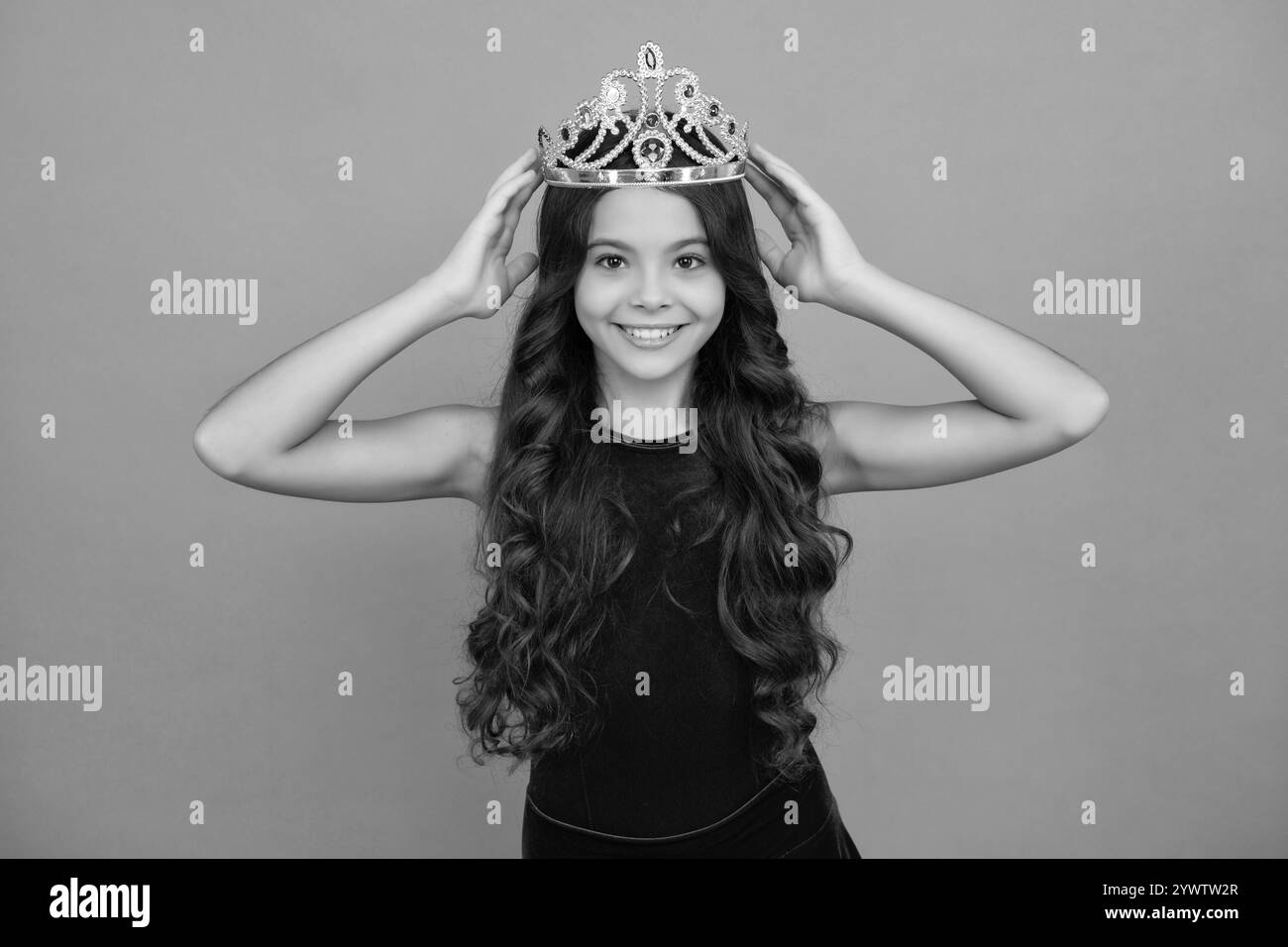 Little queen wearing golden crown. Teenage girl princess holding crown ...