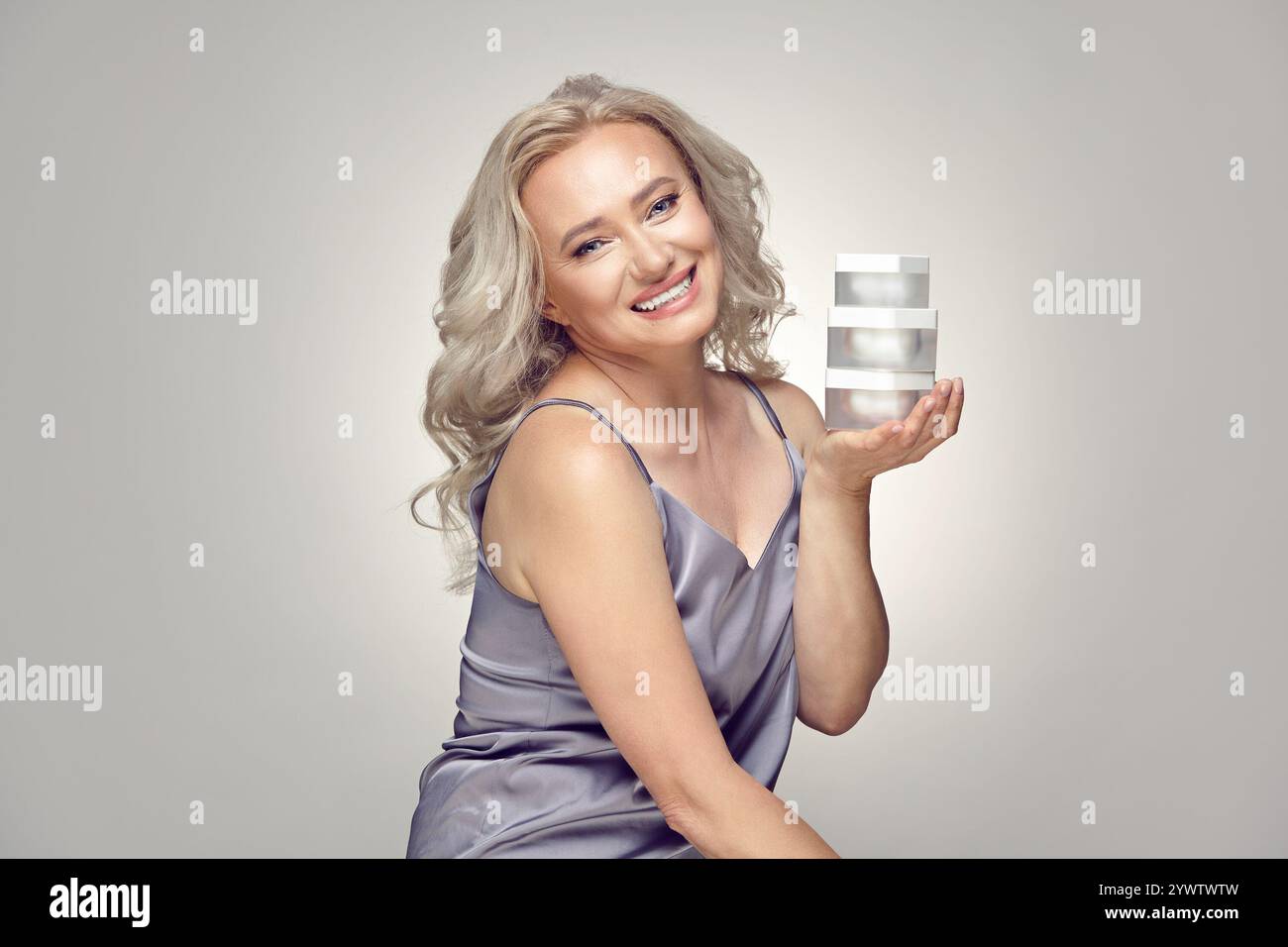Fifty years old caucasian blonde woman holding creams for face Stock ...