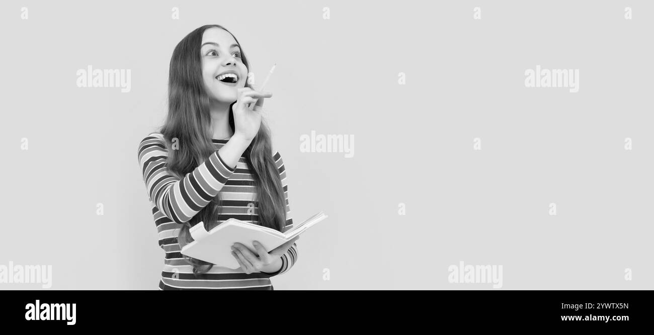 Happy kid genius got inspiration holding book and pointing pen up ...