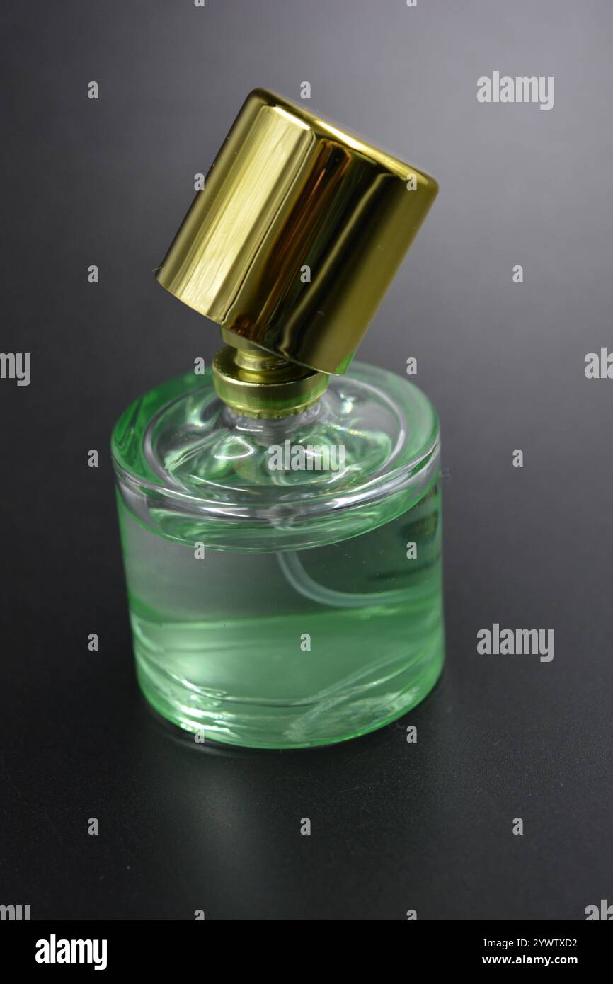 Women's clothes, perfumes, pleasant aromas. Glass bottle with green ...