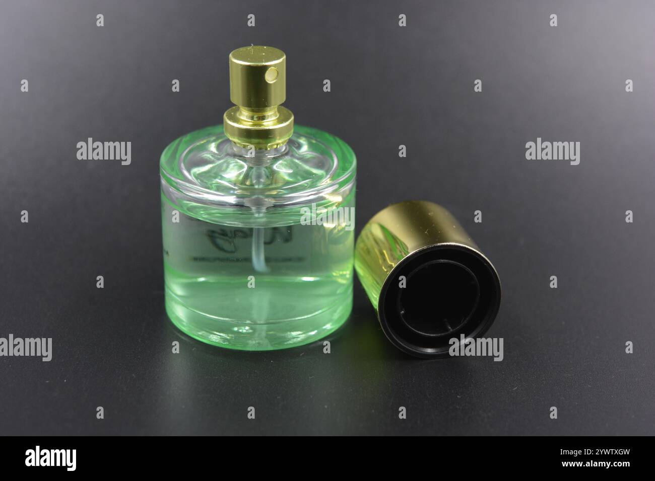 Women's clothes, perfumes, pleasant aromas. Glass bottle with green ...