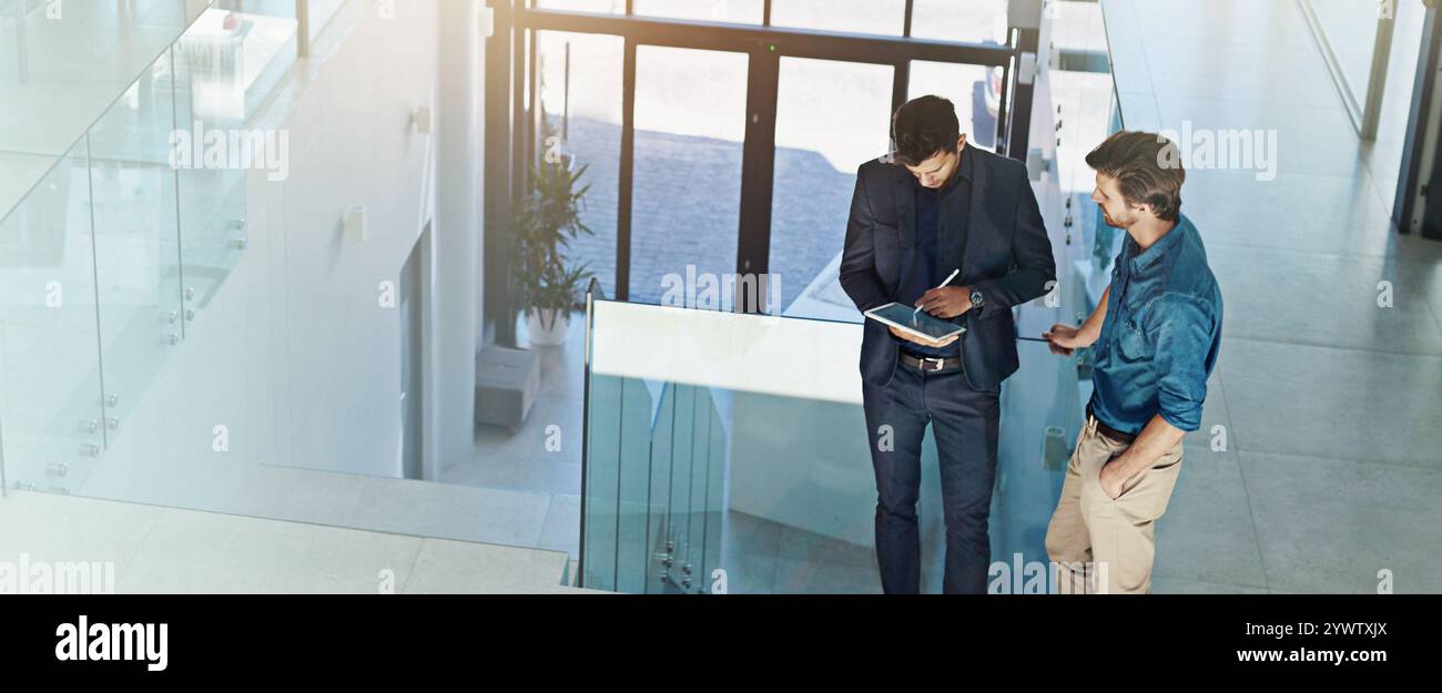 Above, tablet and business people in office, teamwork and conversation ...