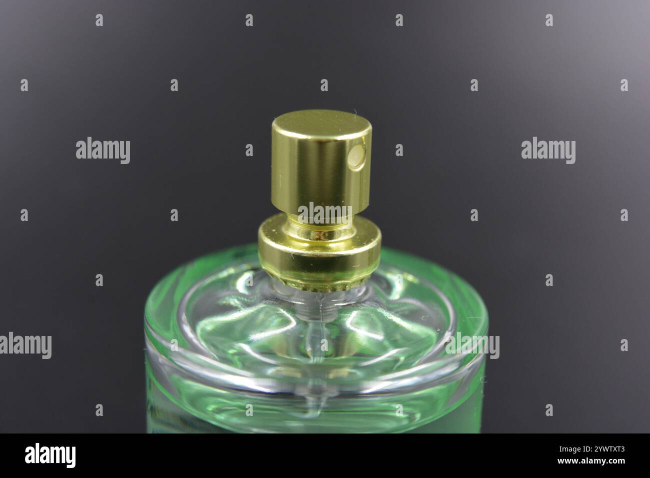 Women's clothes, perfumes, pleasant aromas. Glass bottle with green ...